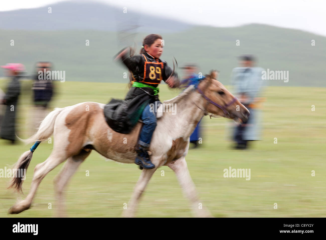 Mongolian child horse racing at Naadam festival in Tsagaannuur ...