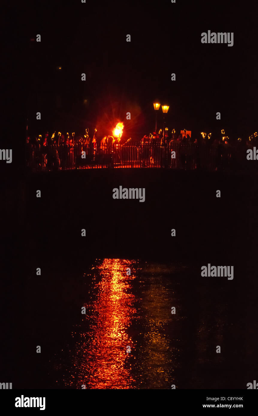 Cliffe Bonfire Society march across a bridge over the River Ouse in the ...