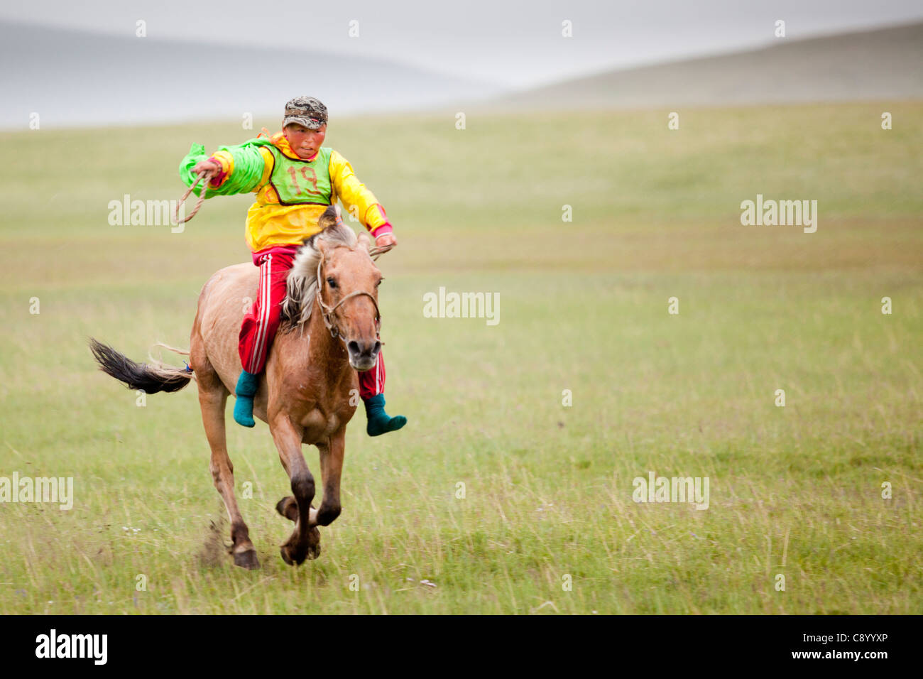 Mongolian child horse racing at Naadam festival in Tsagaannuur ...