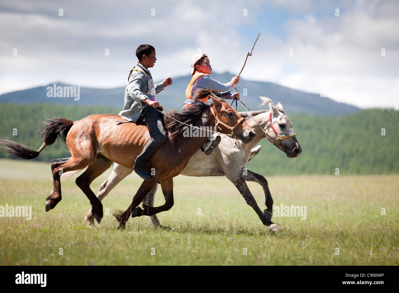 Mongolian child horse racing at Naadam festival in Tsagaannuur ...