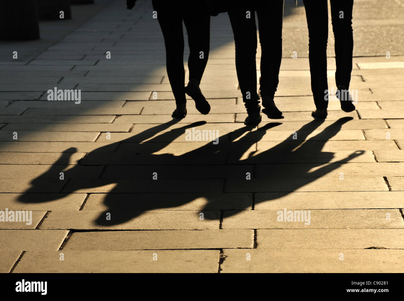 Three people legs shadow hi-res stock photography and images - Alamy