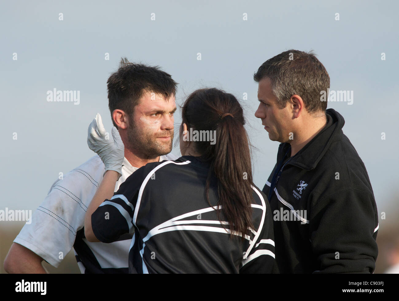rugby player receives attention for cut on face Stock Photo - Alamy