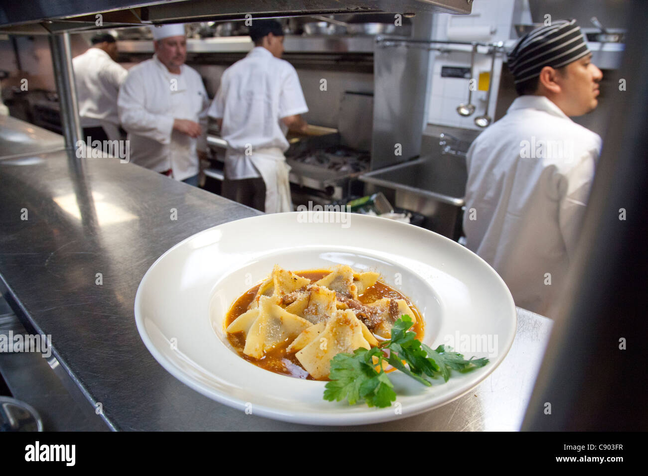 Chef and cooks in restaurant Stock Photo - Alamy