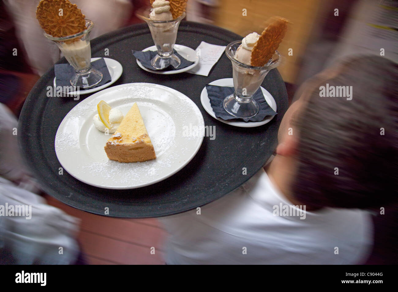 waiter carrying tray with desserts Stock Photo - Alamy