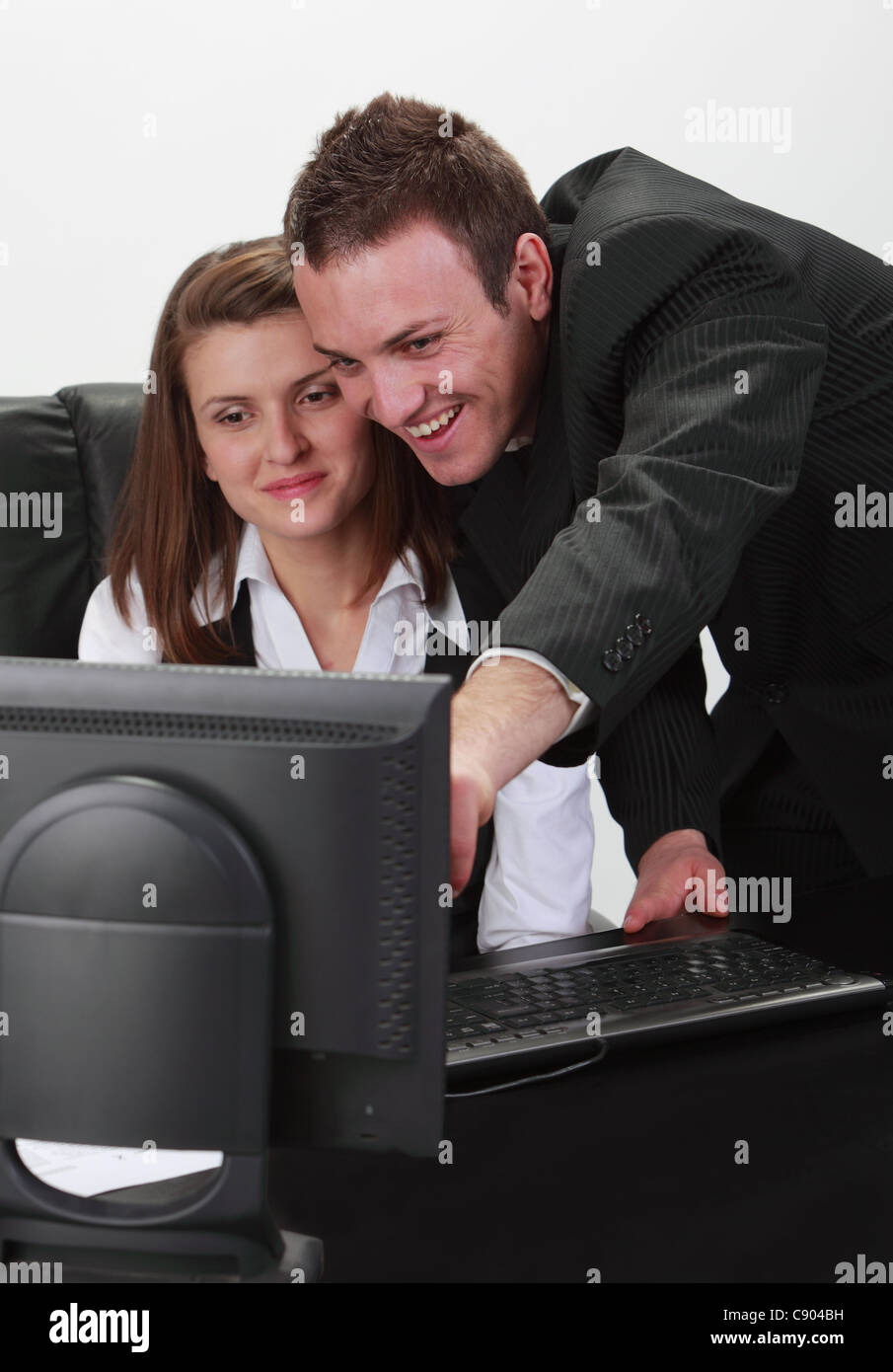 Happpy young businesspersons couple working together on a computer ...