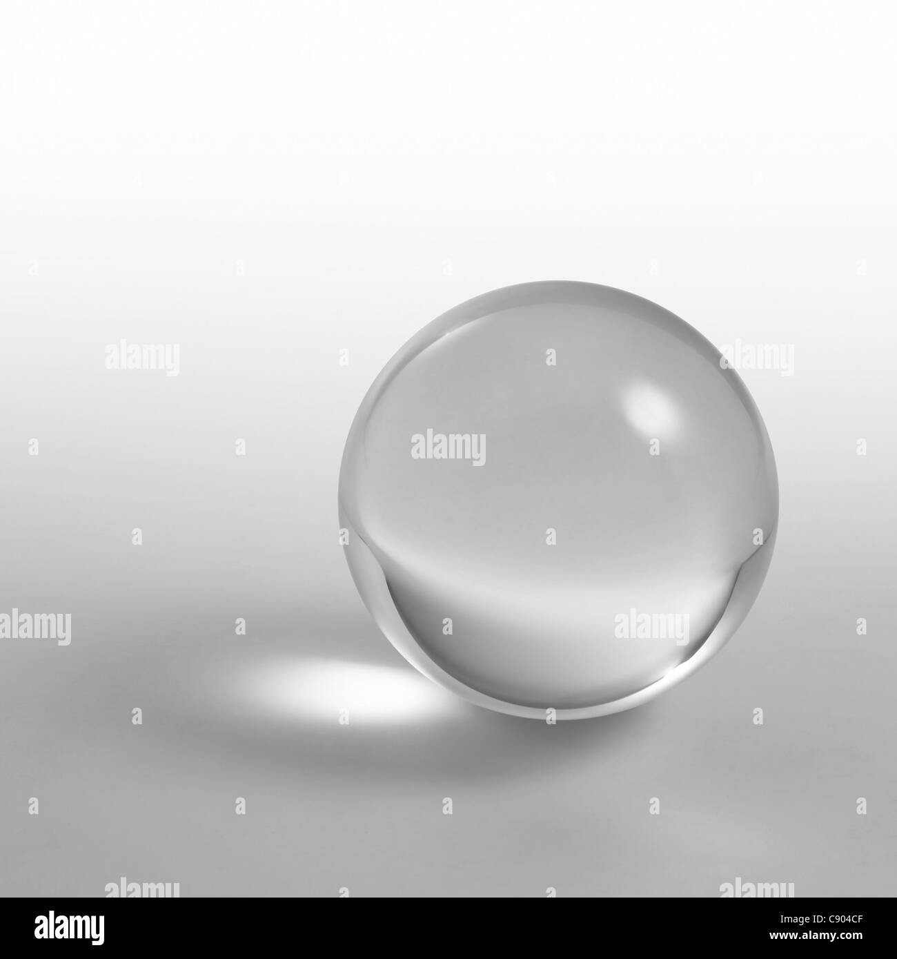 a clear crystal ball and light reflections in grey gradient back Stock ...