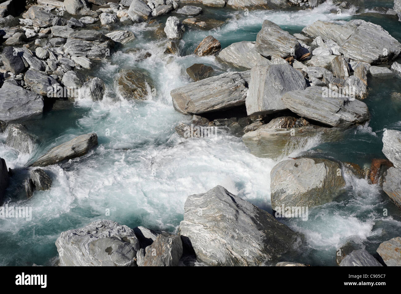Haast River glacial water runs through boulders, Gates of Haast gorge ...