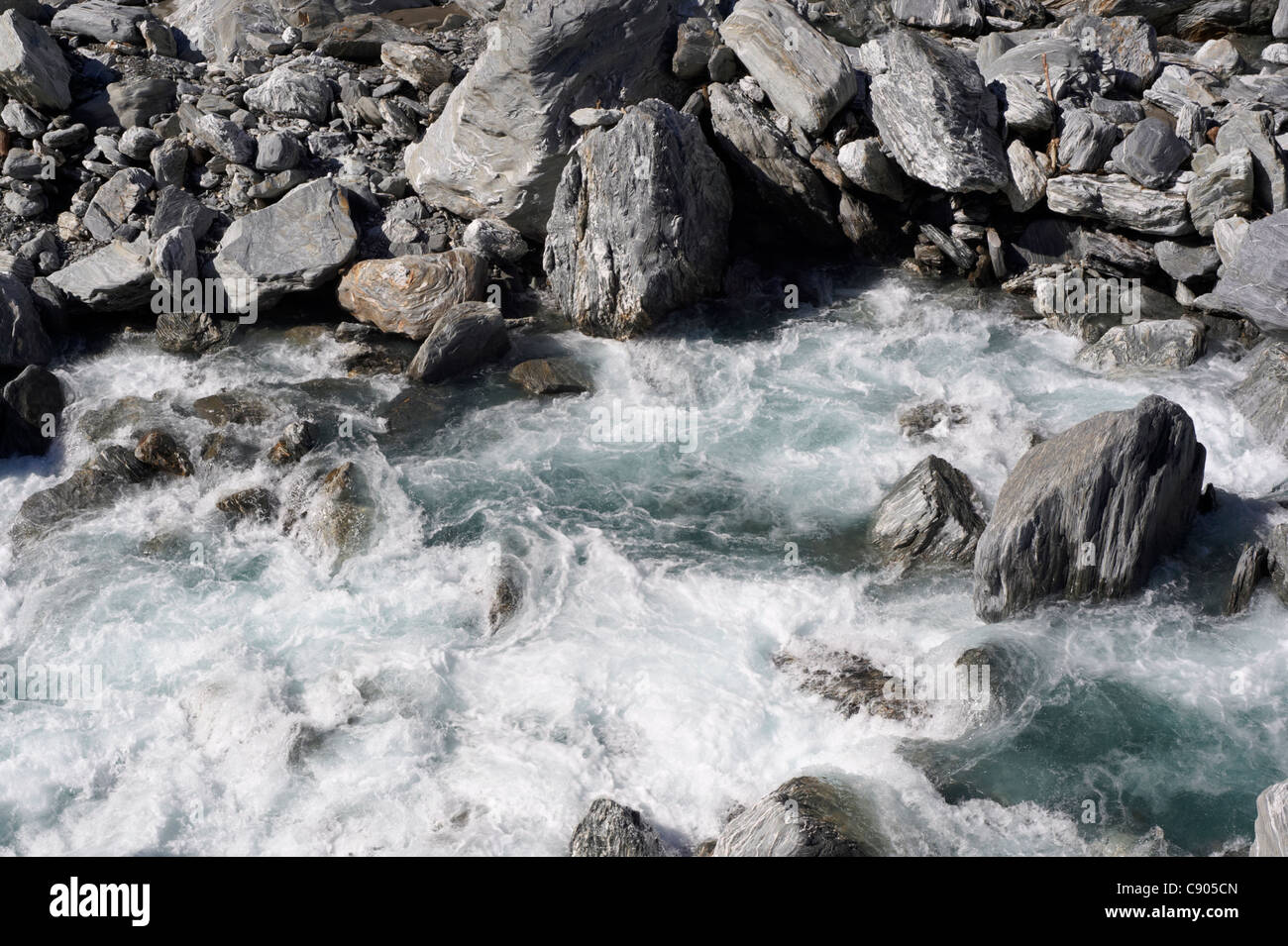 Haast River glacial water runs through boulders, Gates of Haast gorge ...