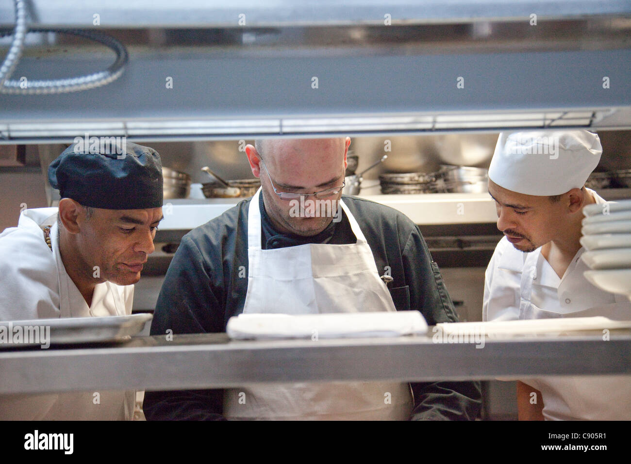 Chef and cooks in restaurant Stock Photo - Alamy