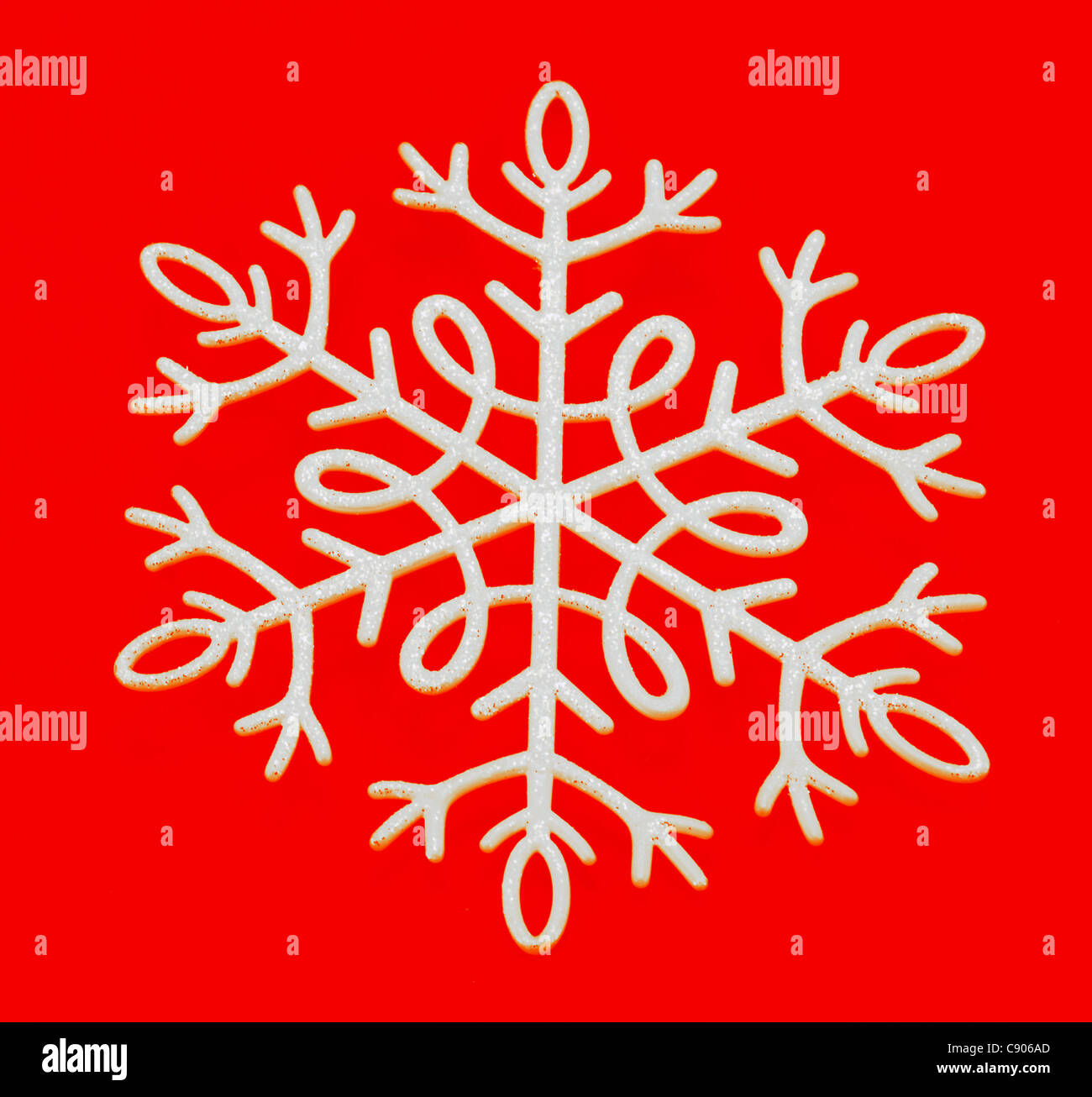 snowflake on red background Stock Photo - Alamy