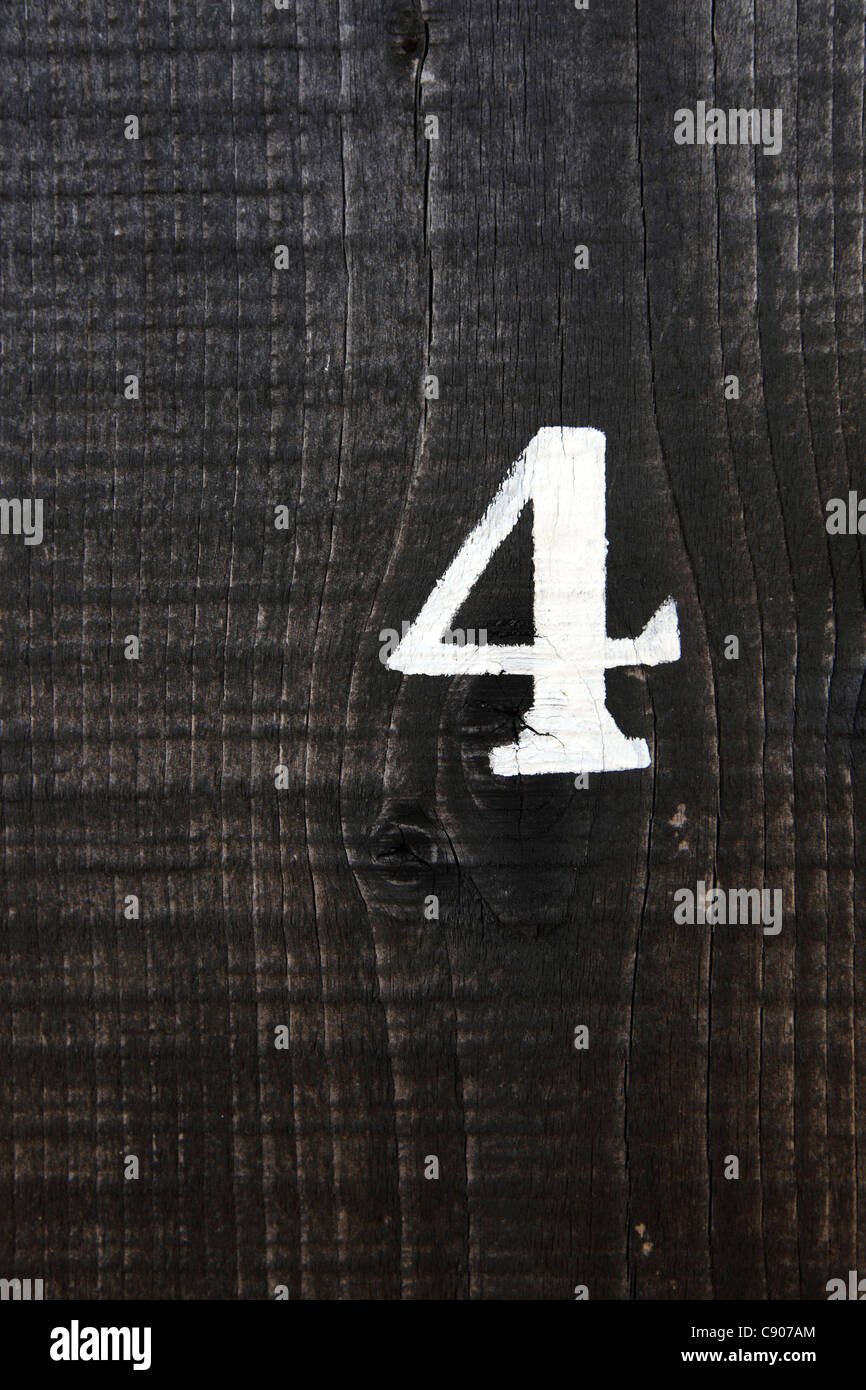 single digit number 4 four stenciled onto stained wooden door, Suffolk ...