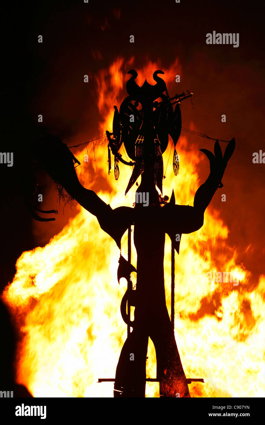 "Wicker Man" sculpture on fire, devil figure burning in red hot flames ...
