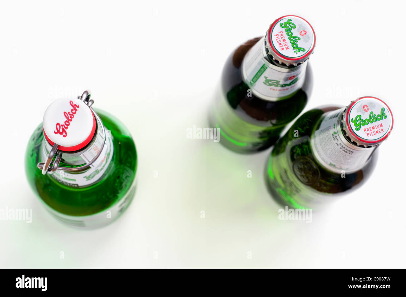 Three beer bottles on a white background Stock Photo - Alamy