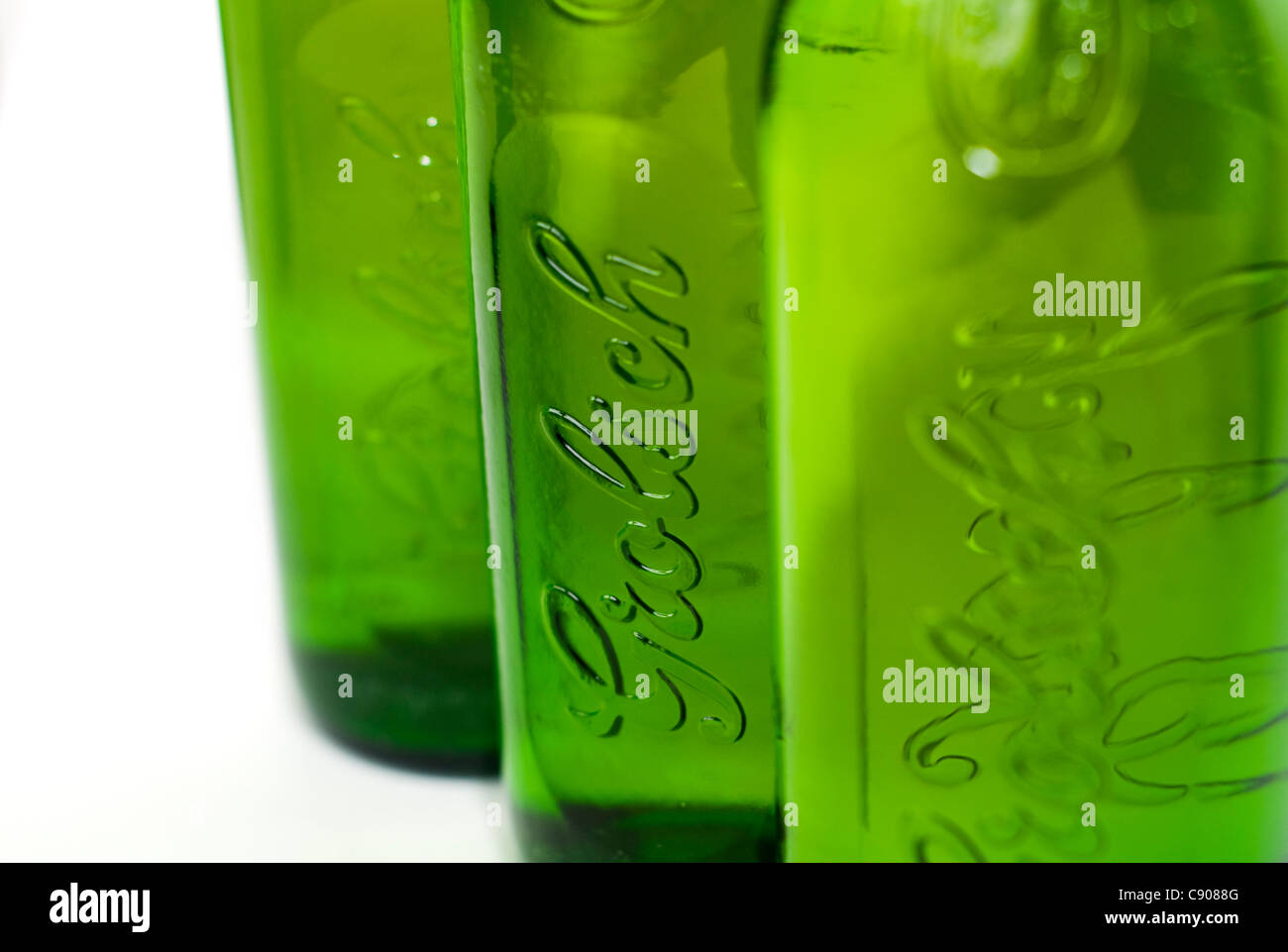 Three empty beer bottles against a white background Stock Photo - Alamy