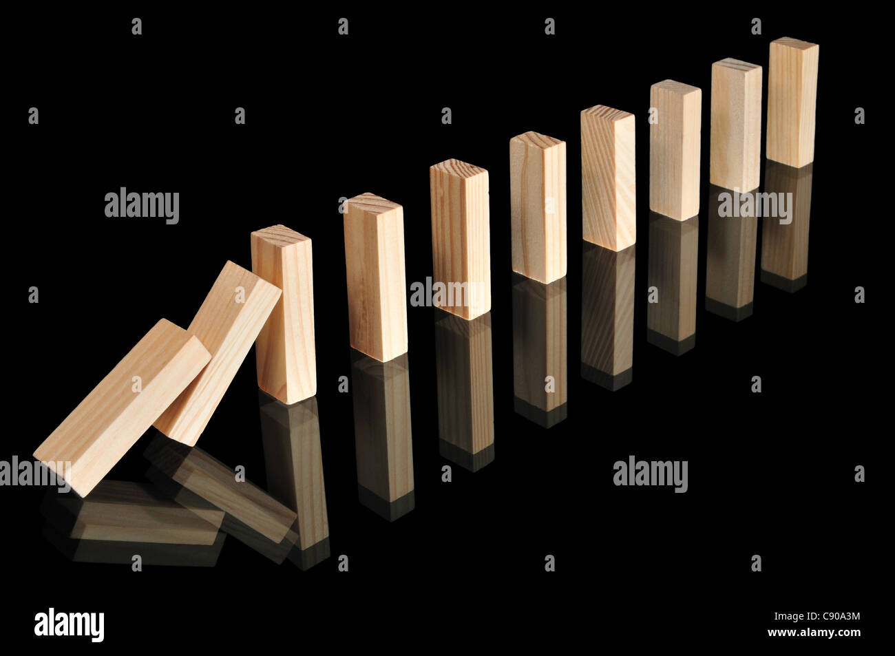 Wooden blocks with reflections representing a chain reaction isolated ...