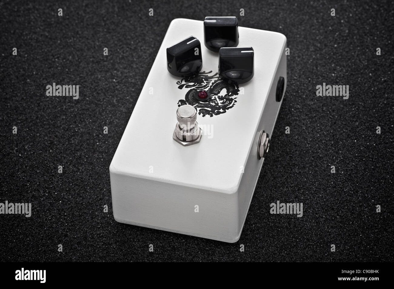 A WHITE DRAGON effect pedal photographed in the studio. It is an effect ...