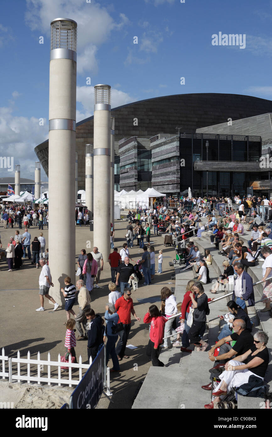 Crowds sitting at the Cardiff Bay Summer Festival, Cardiff Oval basin ...