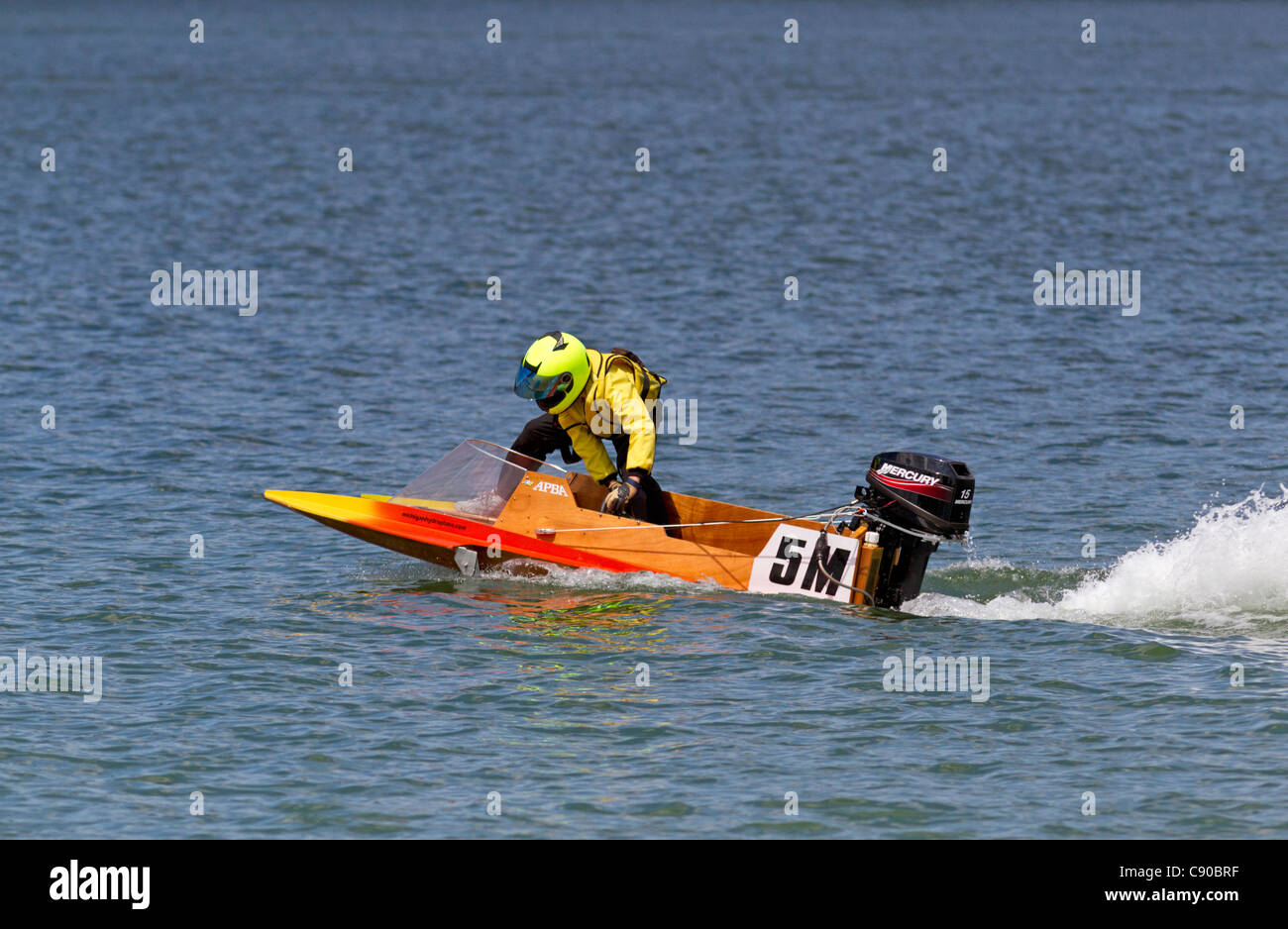 Man slowly accelerating powerboat and balancing weight with engine ...