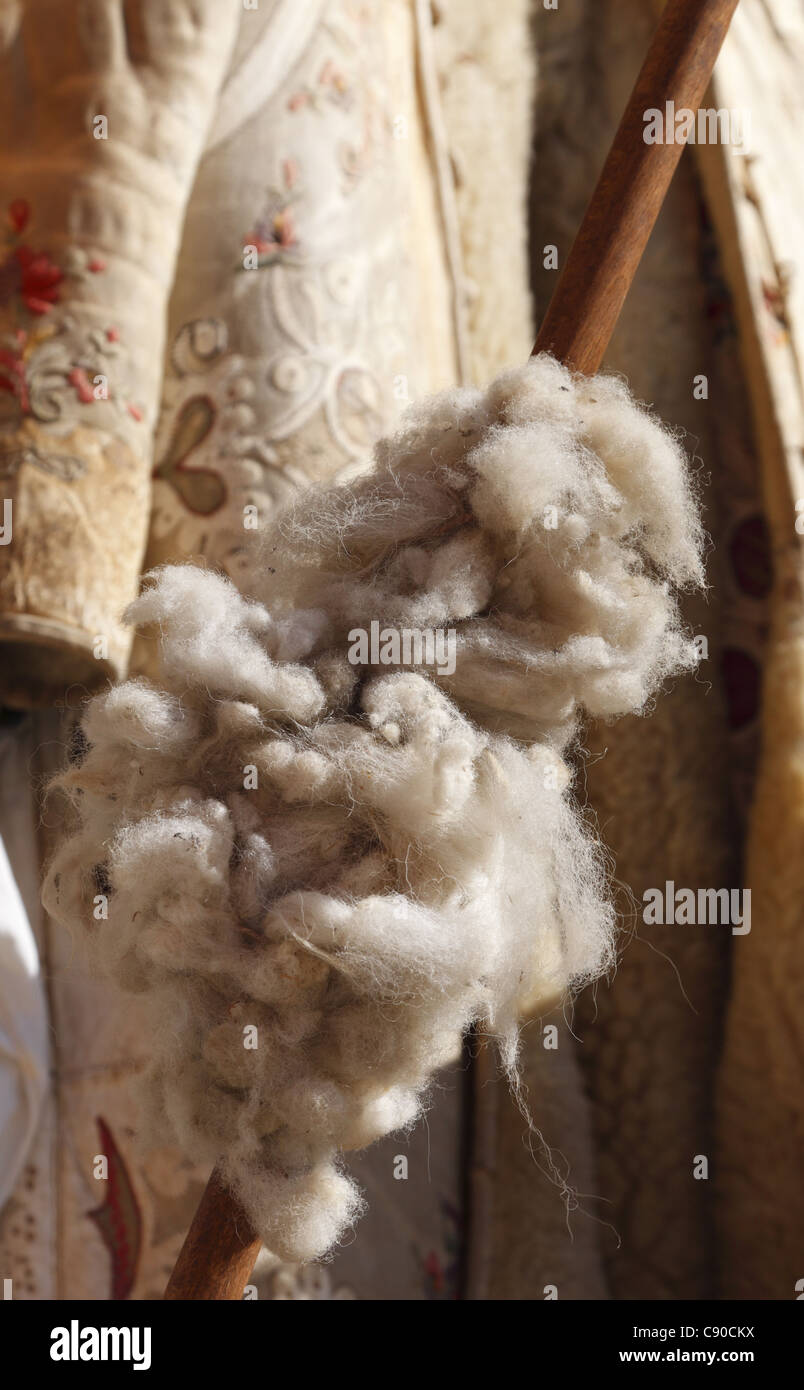 Native wool on a traditional spindle against a background formed of a ...