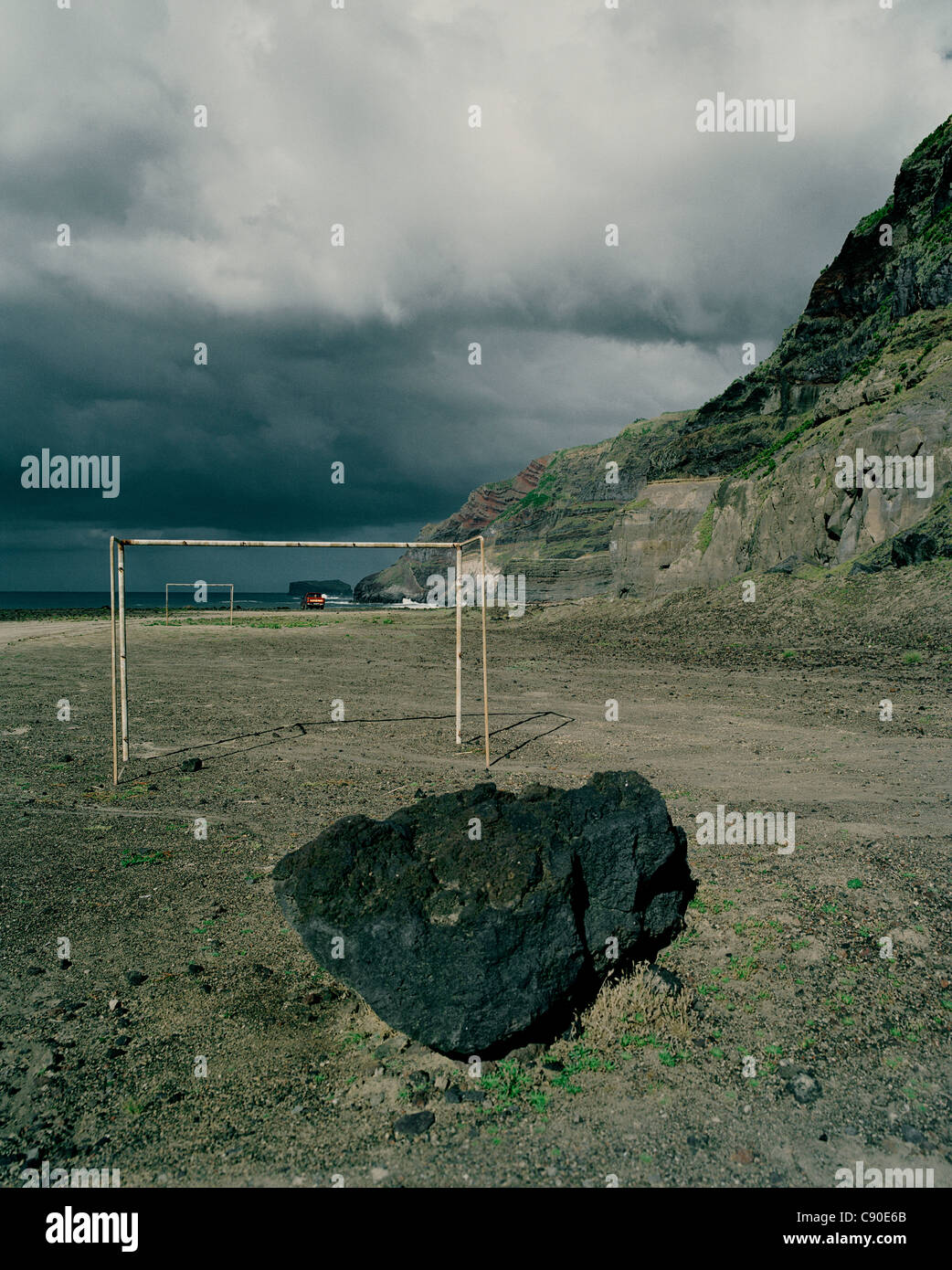 Football field by the ocean volcanic rock in front of cliff line near ...
