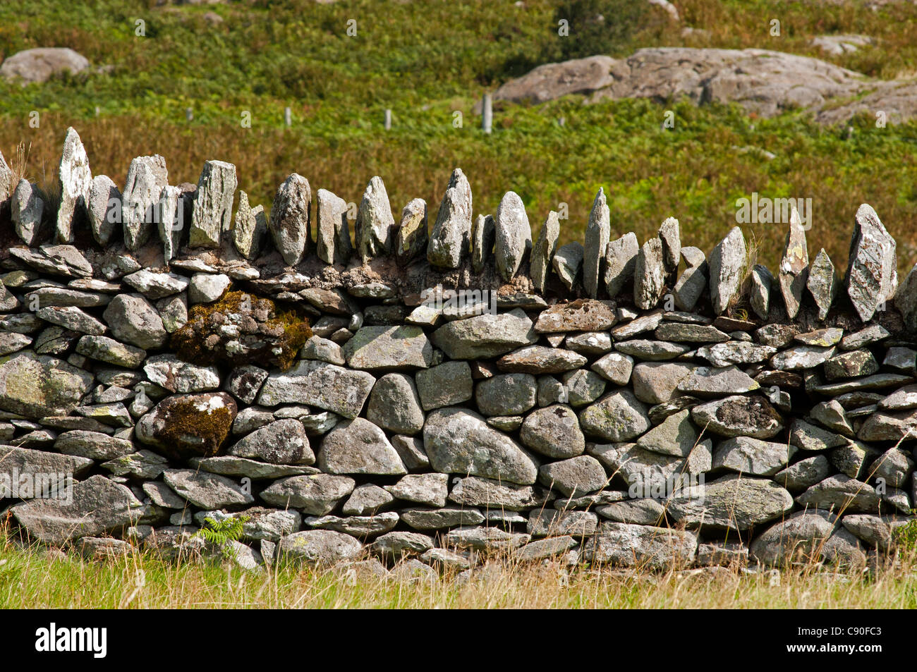 Stone wall of St. Celynin's church above Rowen, Snowdonia National Park ...
