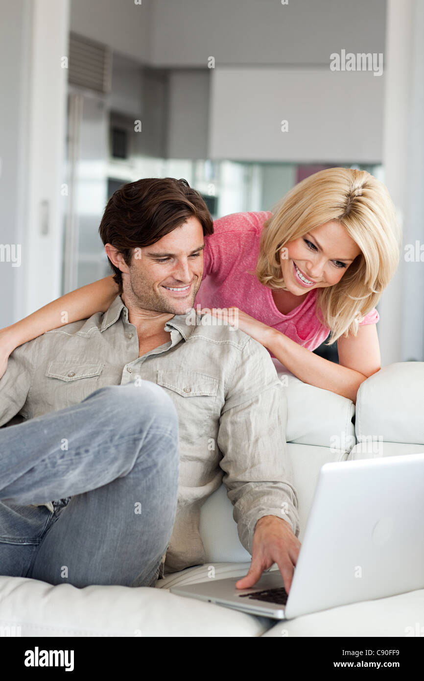 Couple using laptop at home Stock Photo - Alamy