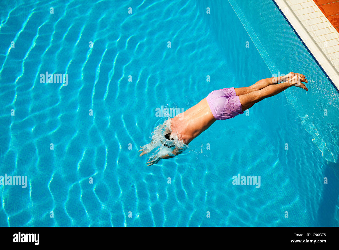 Young man diving into swimming pool Stock Photo - Alamy