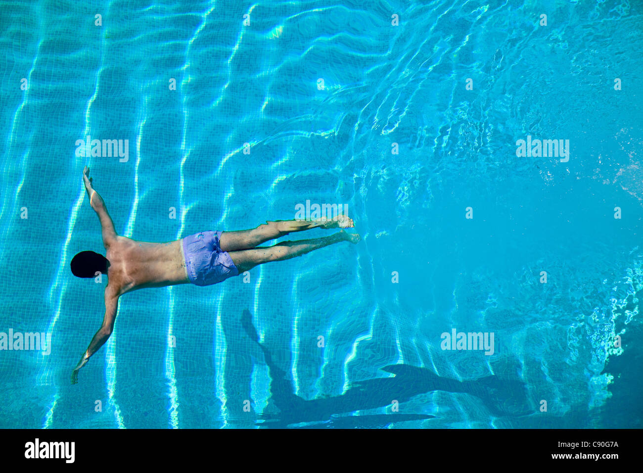 Young man diving into swimming pool Stock Photo - Alamy