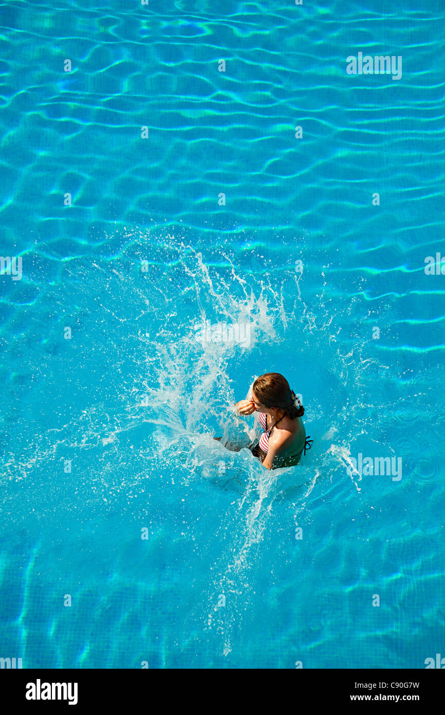 Young woman jumping into swimming pool Stock Photo - Alamy