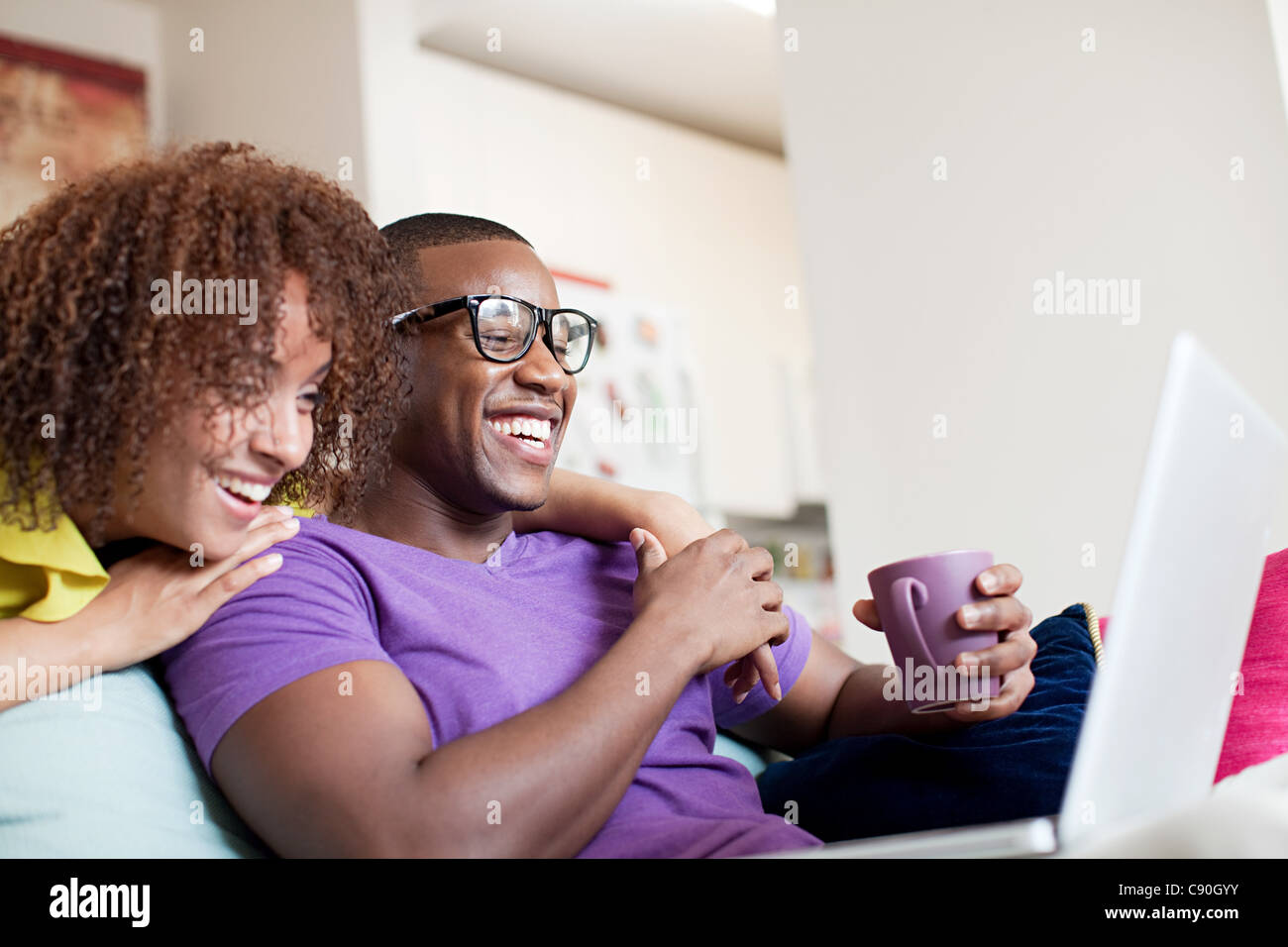 Man using laptop woman looking over his shoulder Stock Photo - Alamy