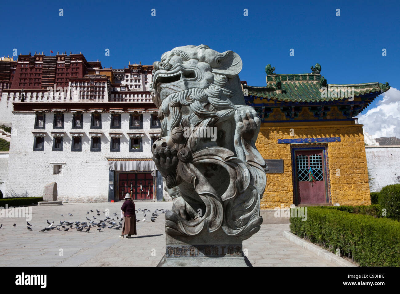 Lion statue in front of the Potala Palace residence and government seat ...