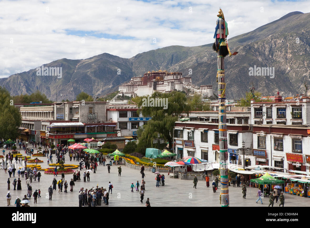 Pilgrims at Barkhor Square in the old part of Lhasa with Potala, Tibet ...