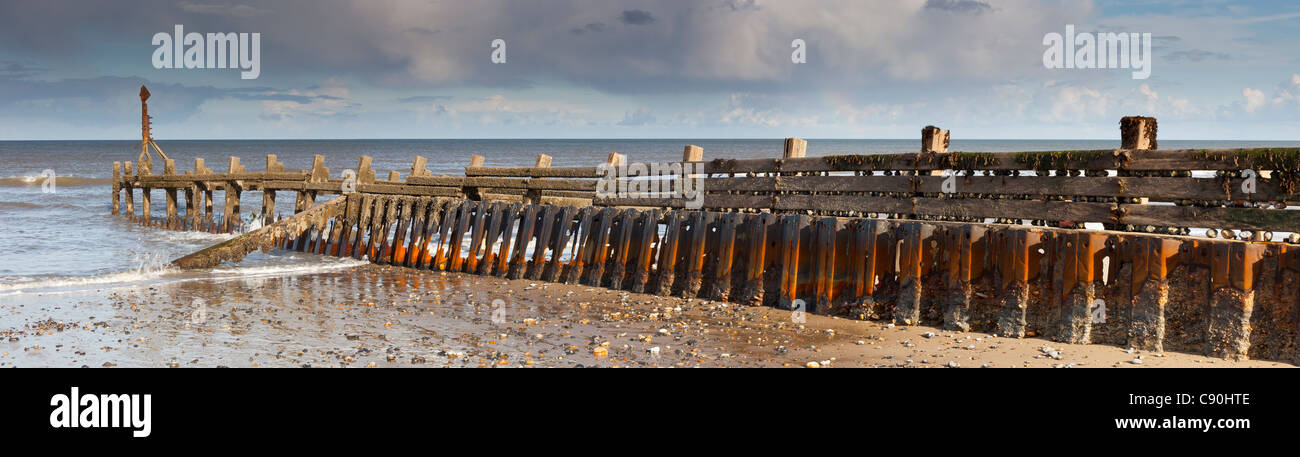 A twisted groyne on Walcott beach at low tide on the north Norfolk ...