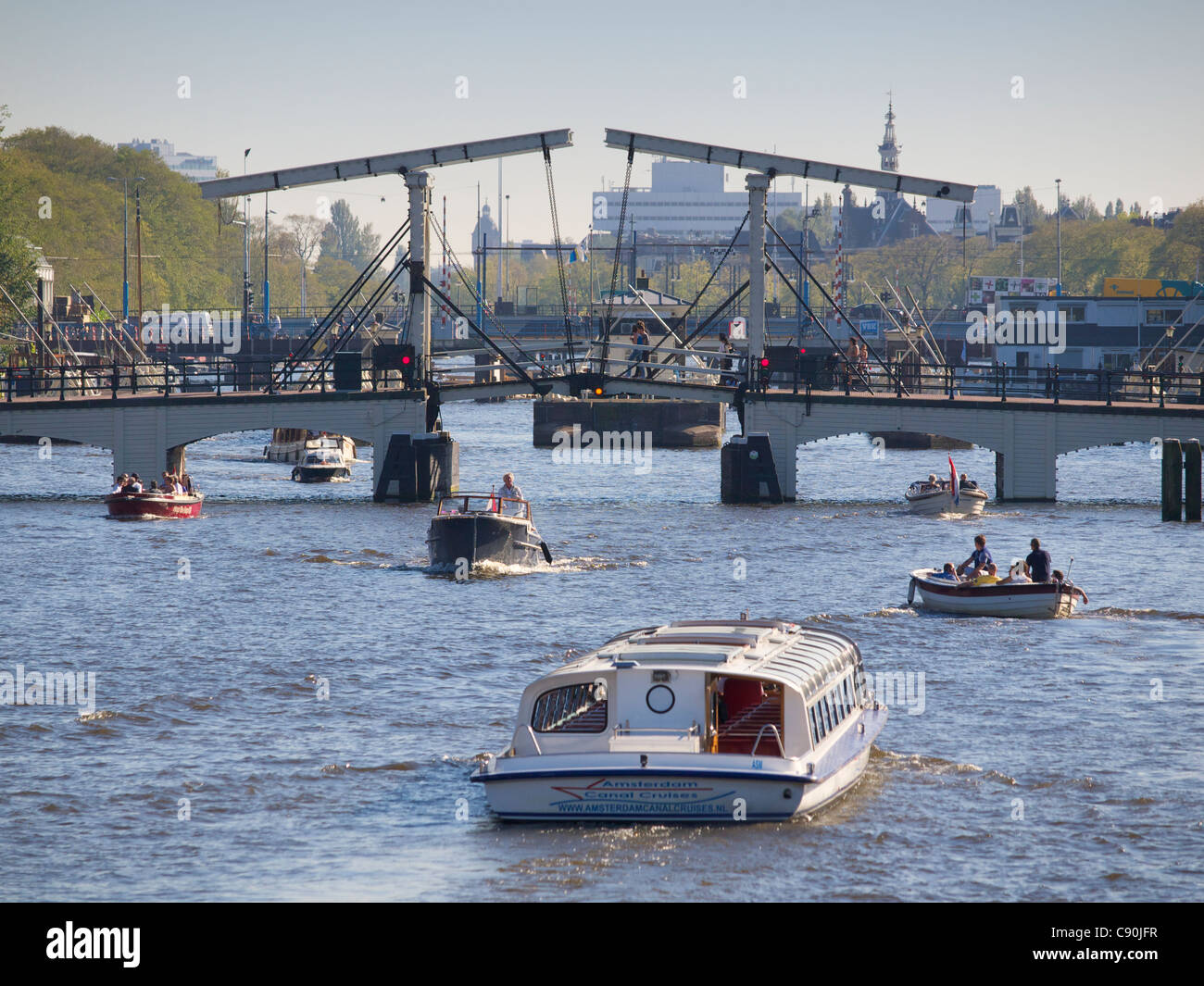 Busy traffic many boats on the Amstel river in the city centre of ...
