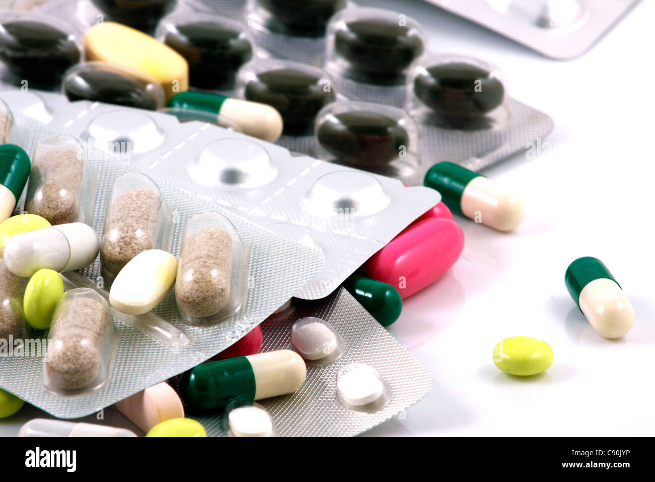 Pills of many shapes and colors Stock Photo - Alamy