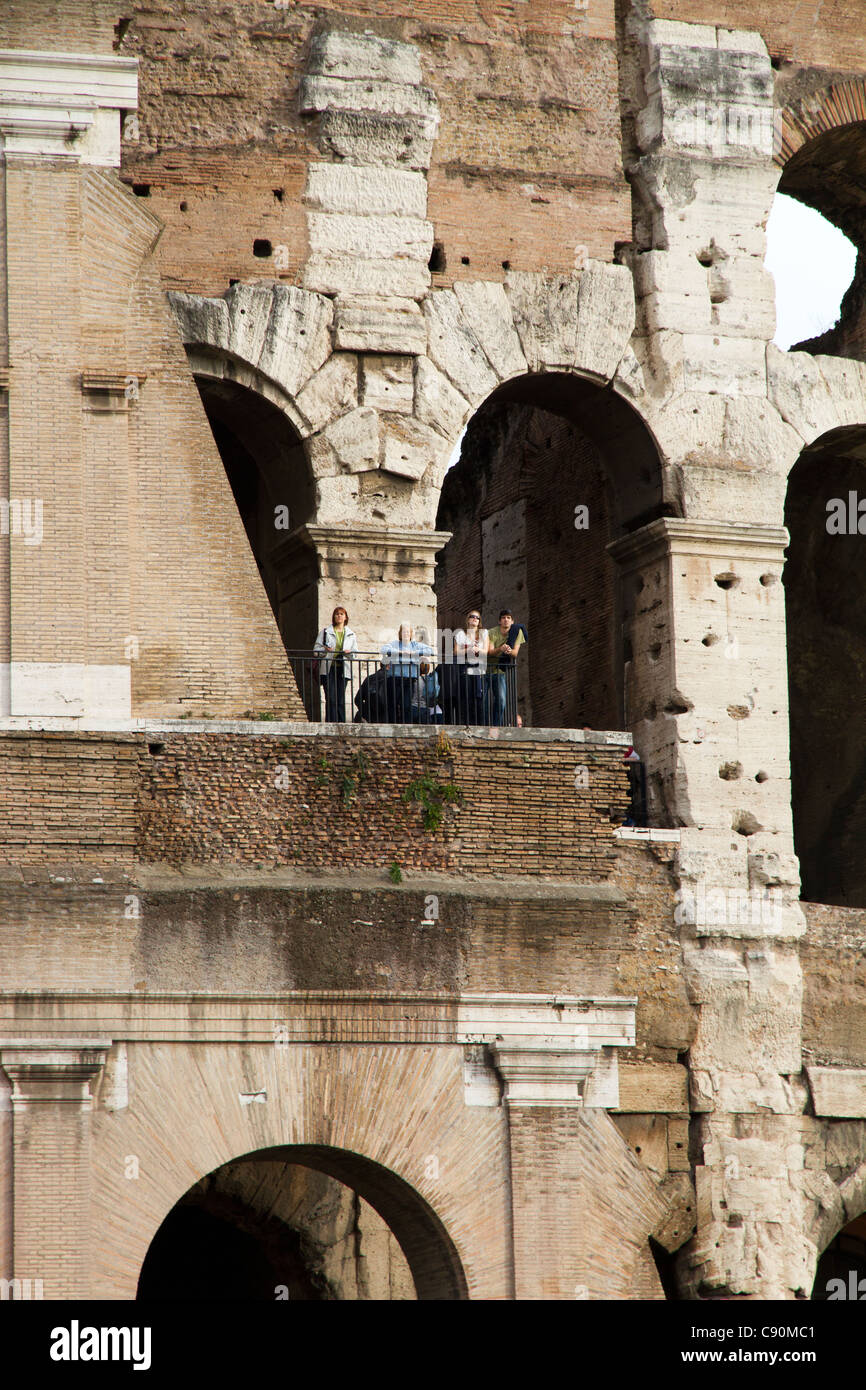 Tourists looking out from a balcony of Colosseum monument, Rome Italy ...