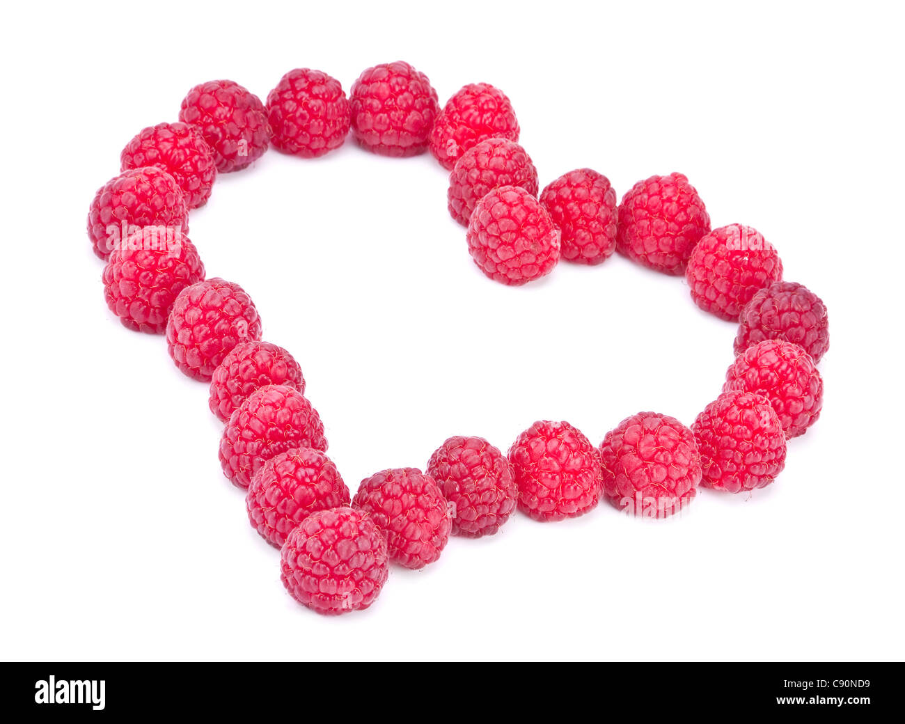 Raspberry as heart isolated on white background Stock Photo - Alamy
