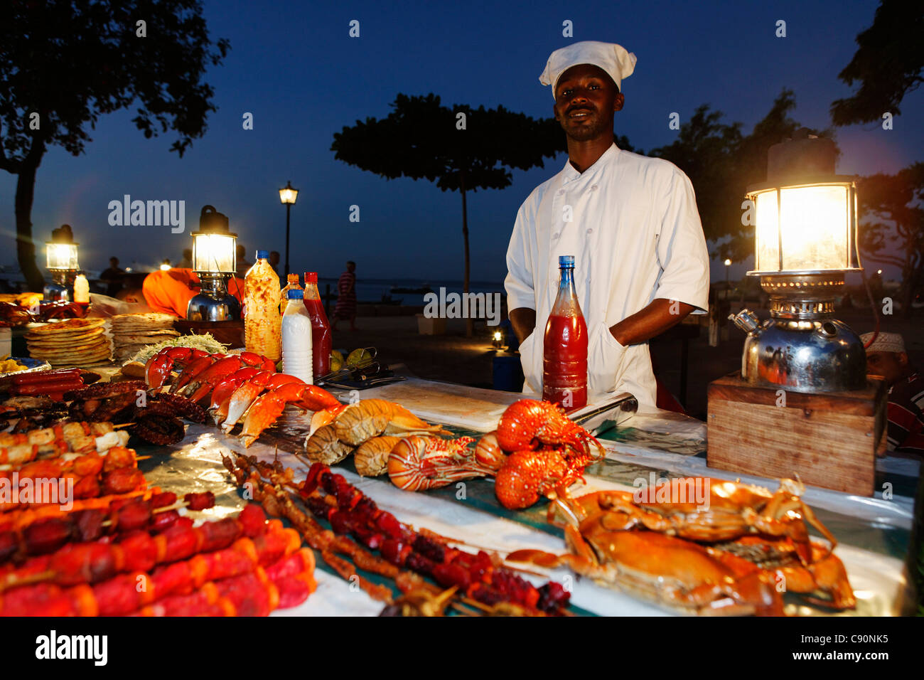 Monger at a stand, night market at Forodhani Gardens, Stonetown ...