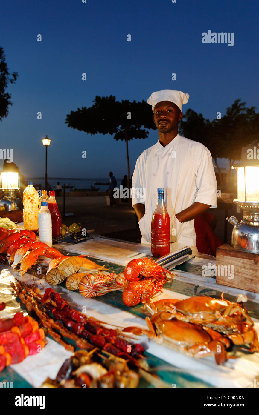 Monger at a stand, night market at Forodhani Gardens, Stonetown ...