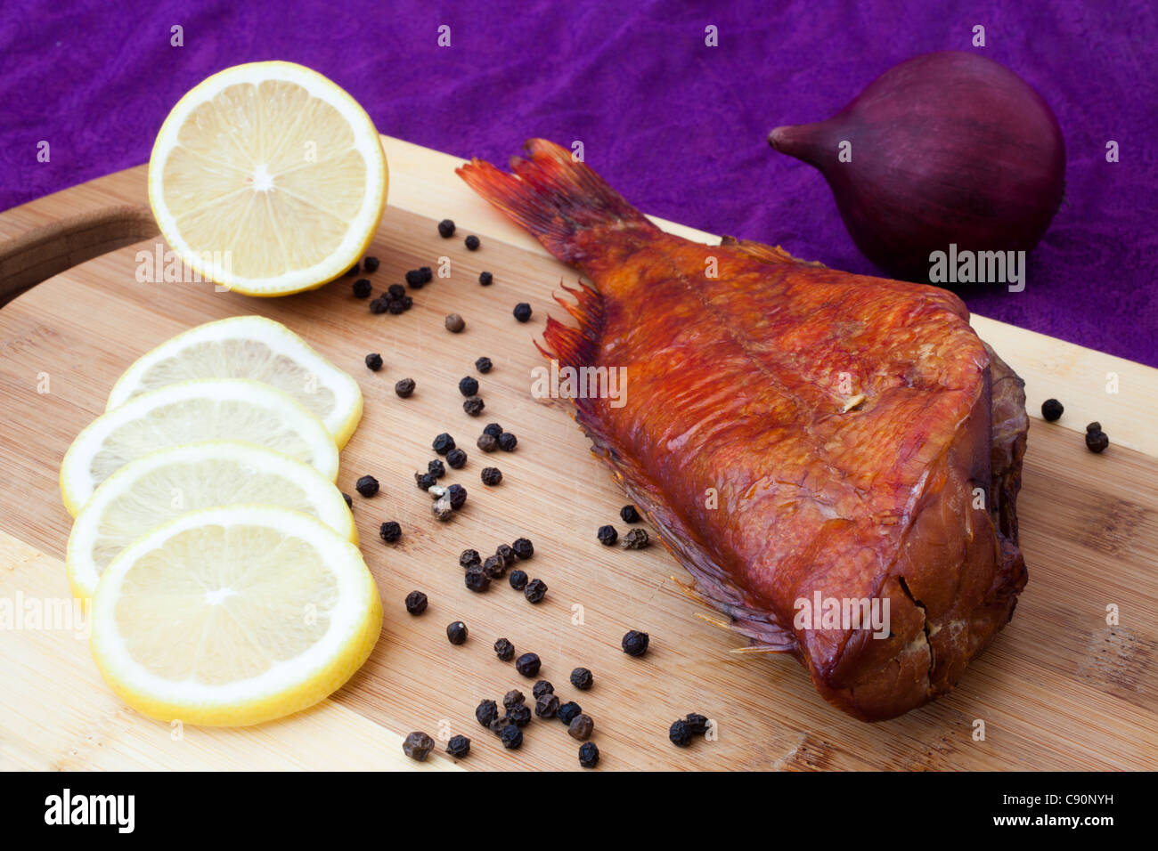 smoked fish on the kitchen board Stock Photo - Alamy