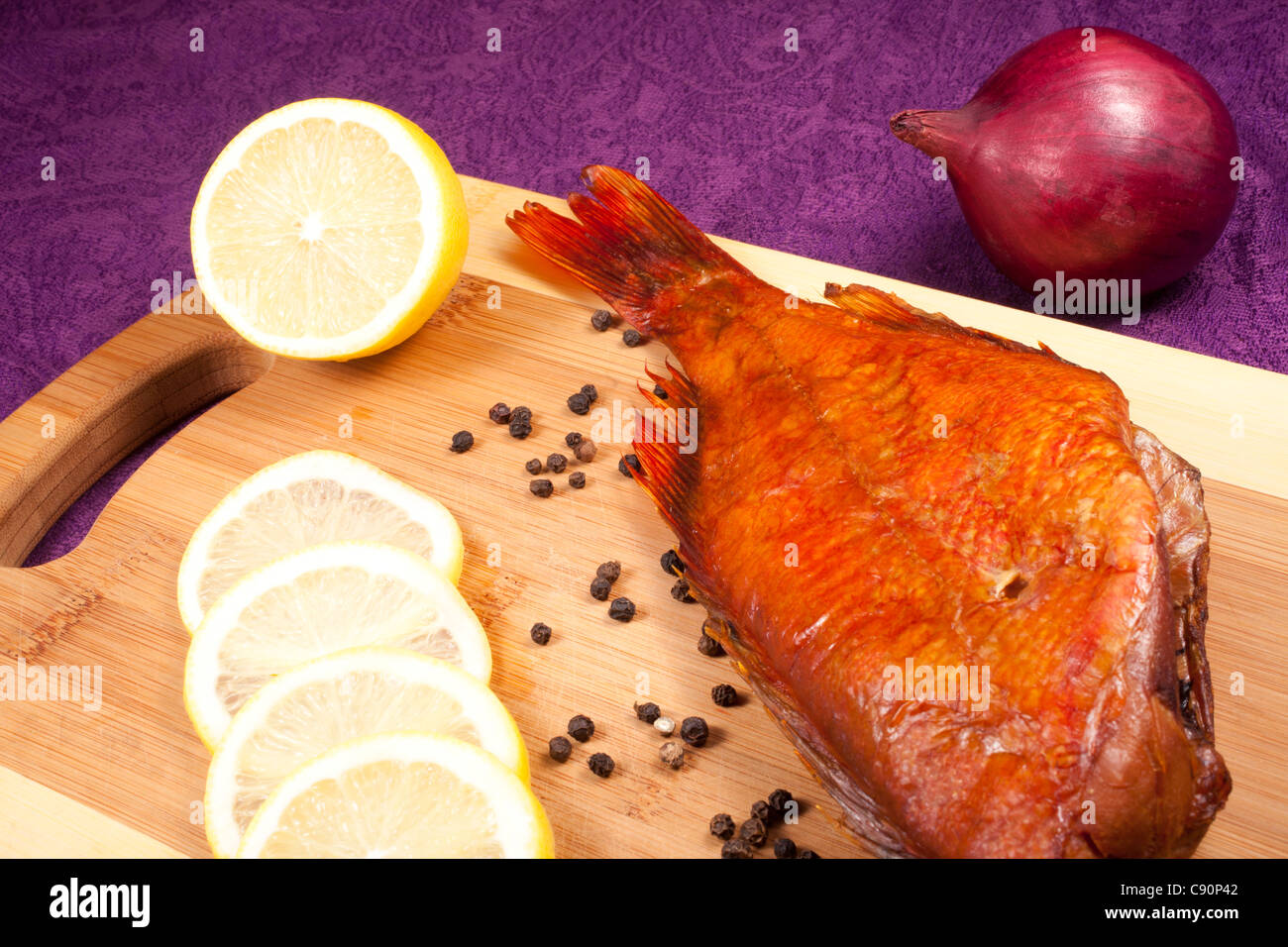 smoked fish on the kitchen board Stock Photo - Alamy