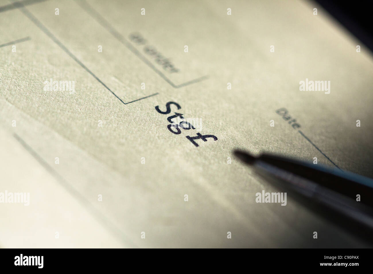 Sterling cheque with pen Stock Photo - Alamy