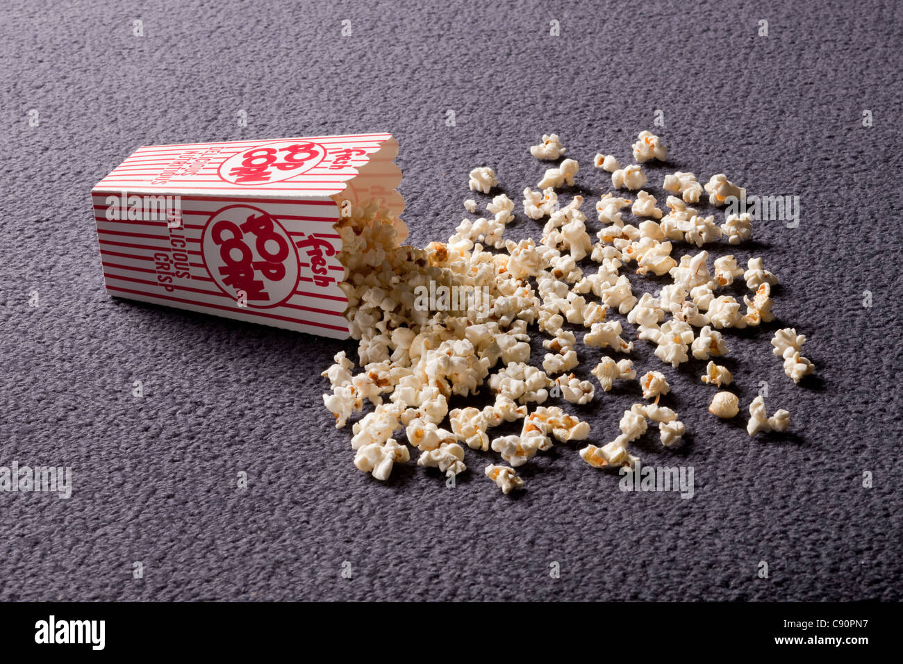 Popcorn spilling on floor Stock Photo - Alamy