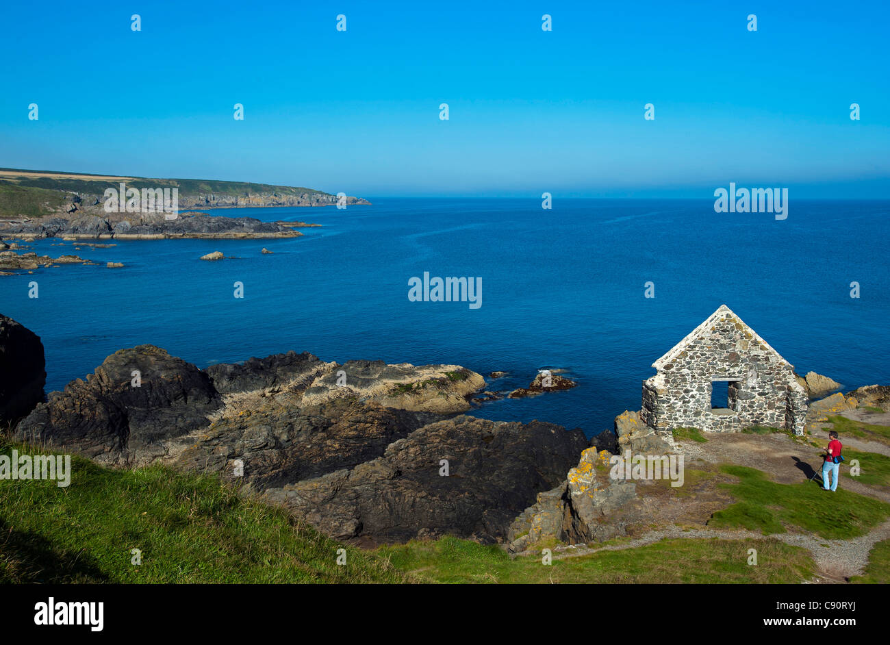 Tourist at a ruin above the harbour of Portsoy, Aberdeenshire, Scotland ...