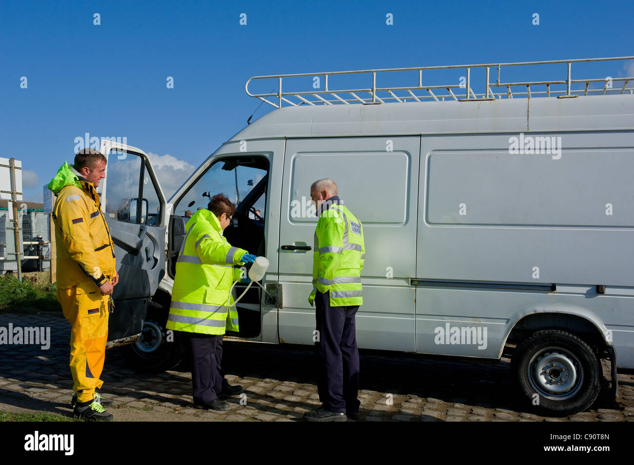 Officers from HM Revenue & Customs carrying a spot check on fuel in a ...
