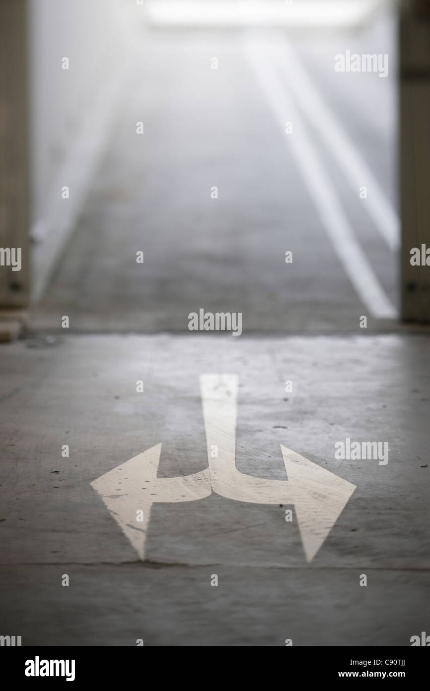 Arrows on ground of an underground garage Stock Photo - Alamy