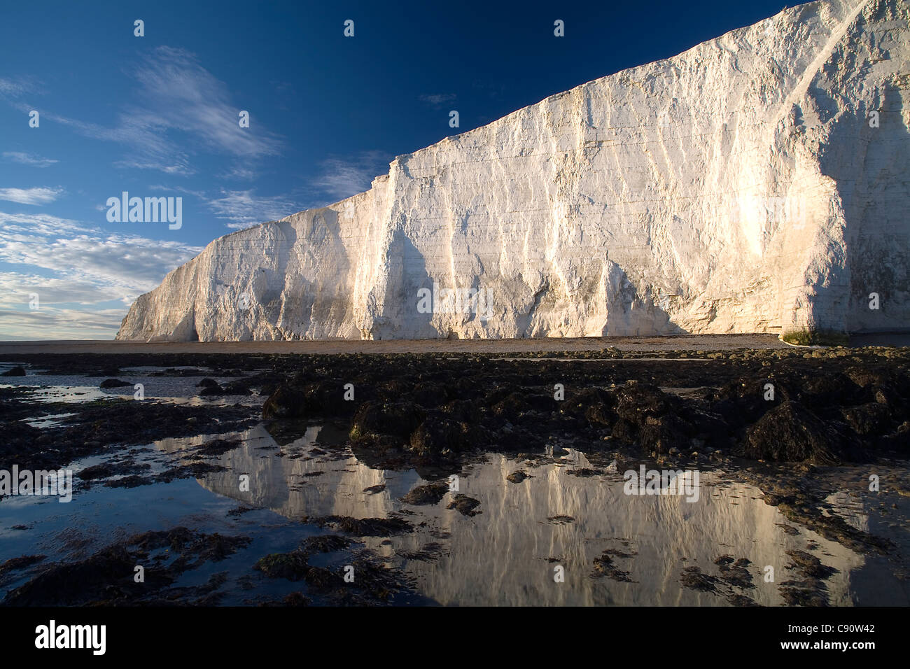 There are sheer vertical chalk cliffs on the coastline of Norfolk near ...