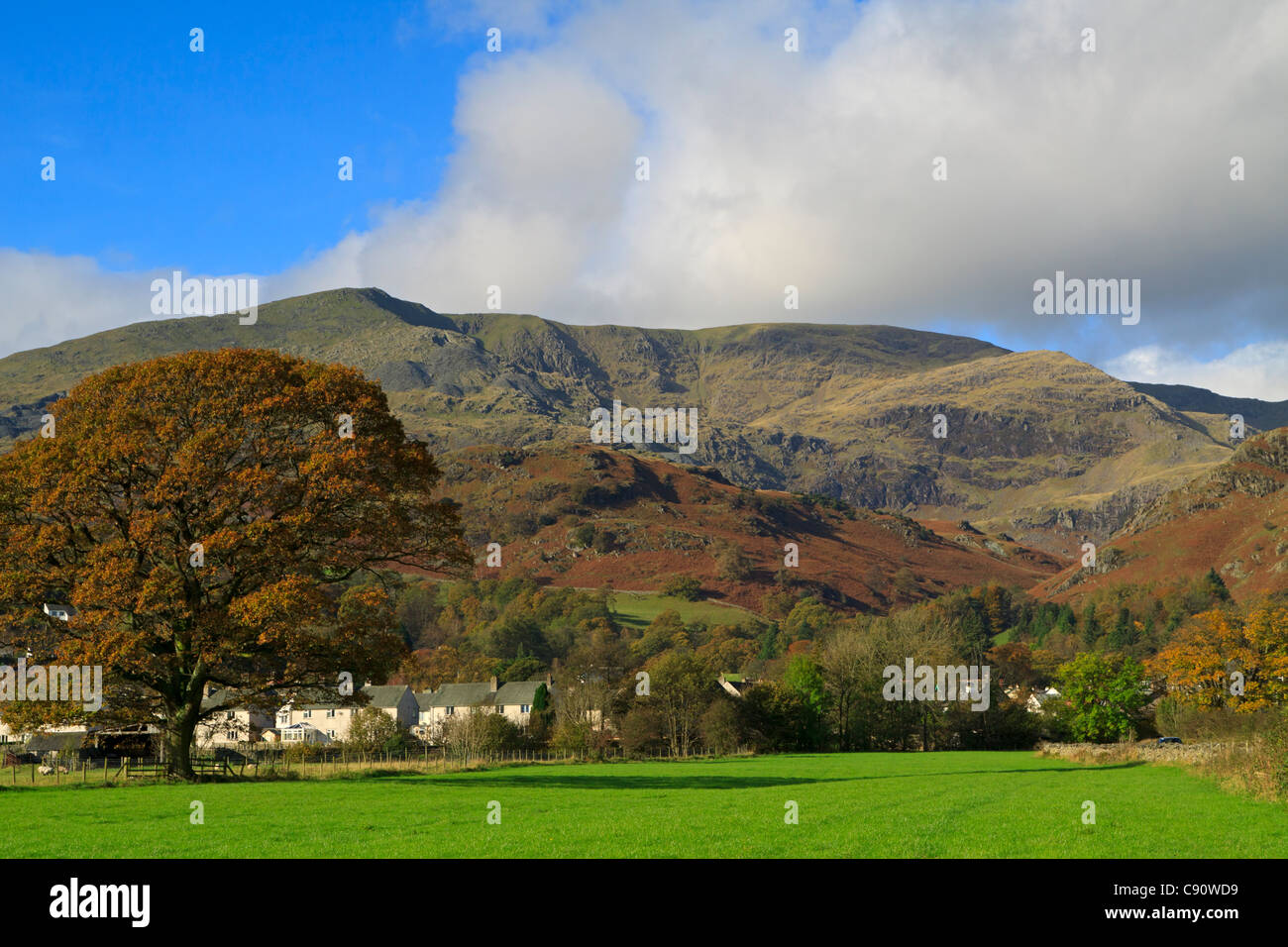 Coniston, Cumbria, UK. Pretty village nestles below the fell known as ...