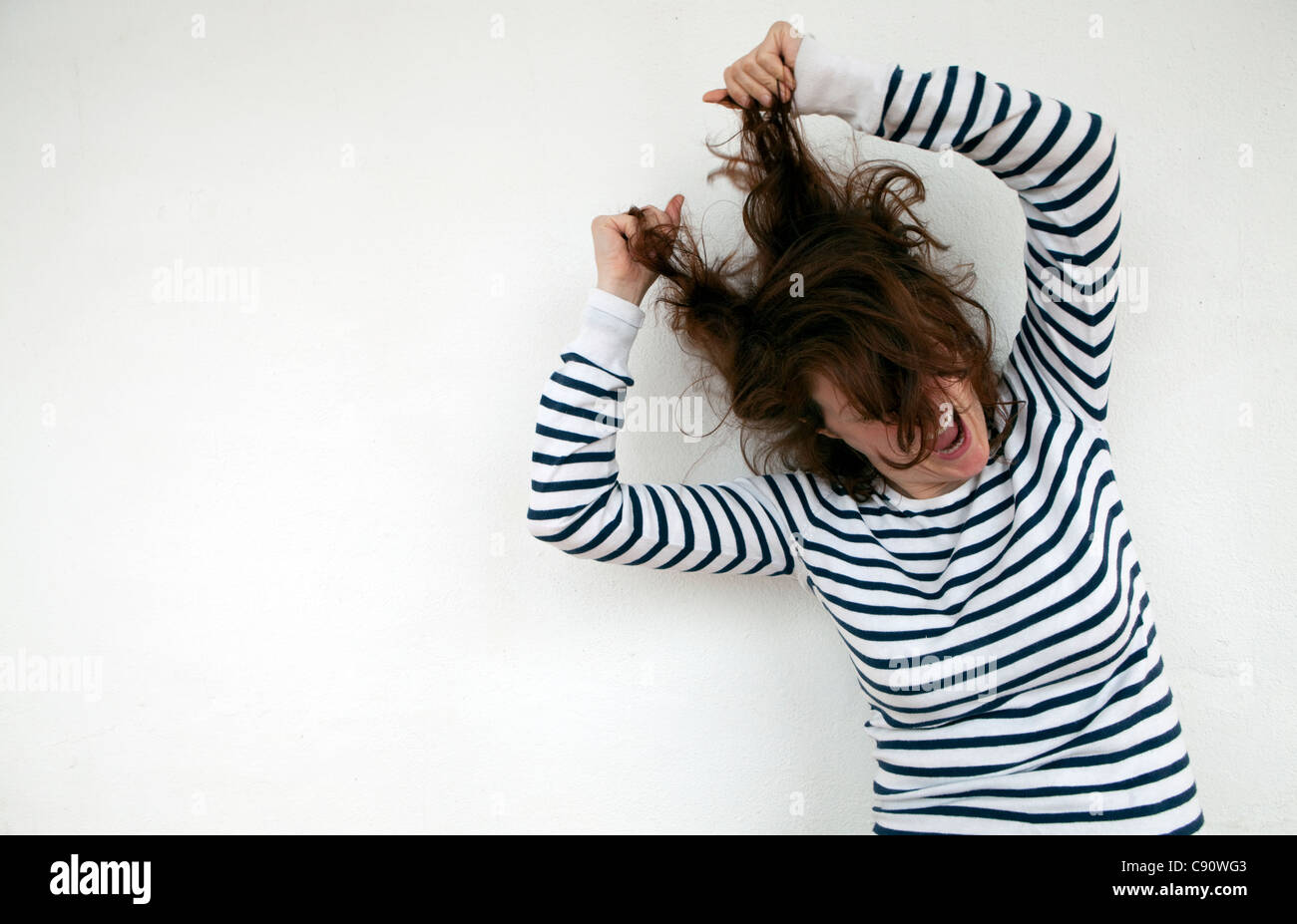 Woman pulling her hair Stock Photo - Alamy