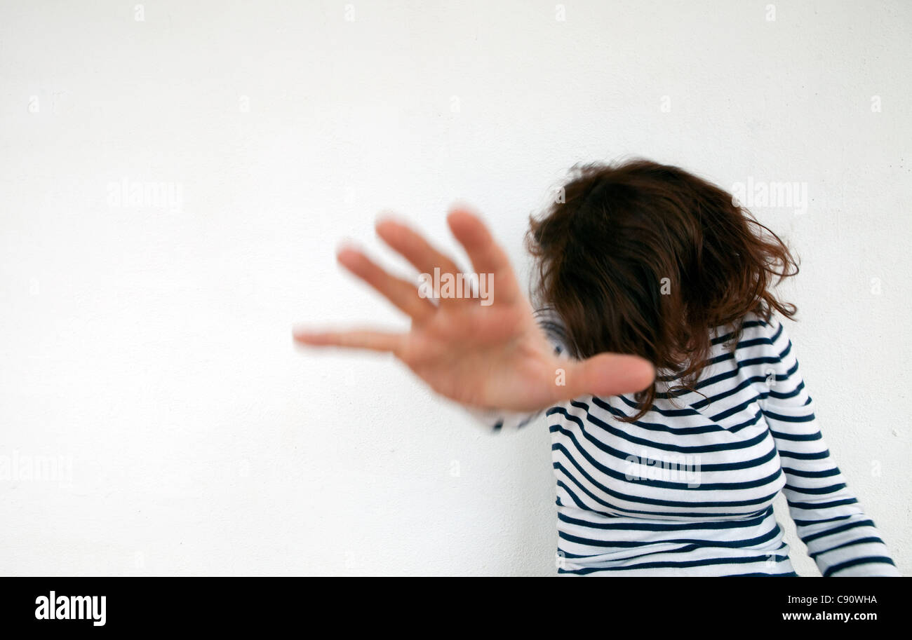 Woman holding hand in front of face Stock Photo - Alamy